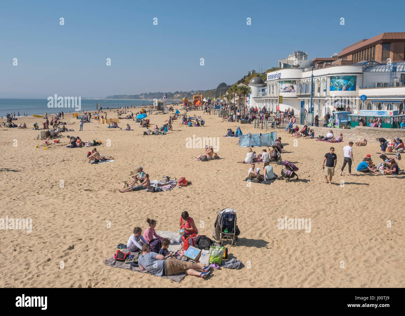 Bournemouth West Beach with people relaxing in the seaside resort on a ...