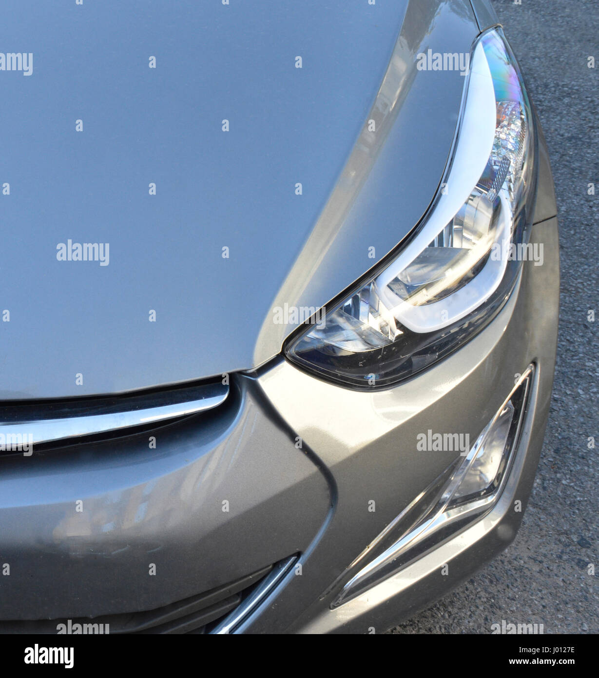 Drivers side view of the front end of a new Car, with headlights ...