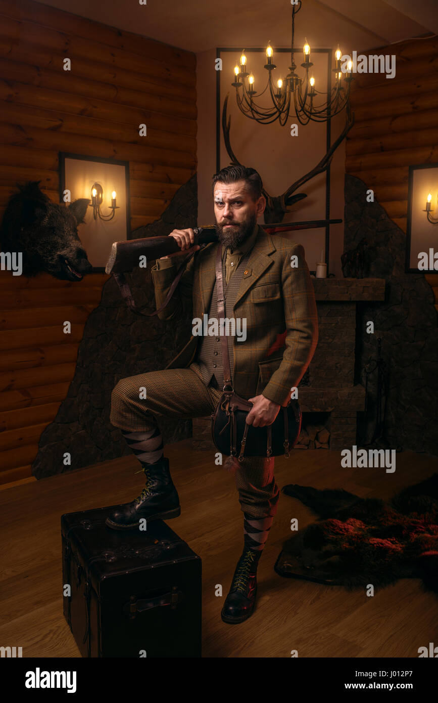 Respectable hunter man with old gun in retrro style traditional hunting ...