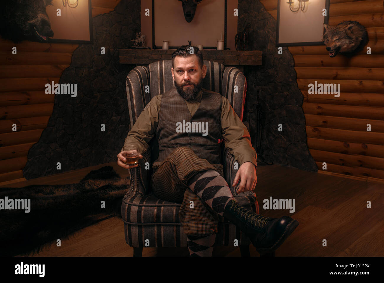 Hunter man in traditional british clothing sitting in a chair after ...