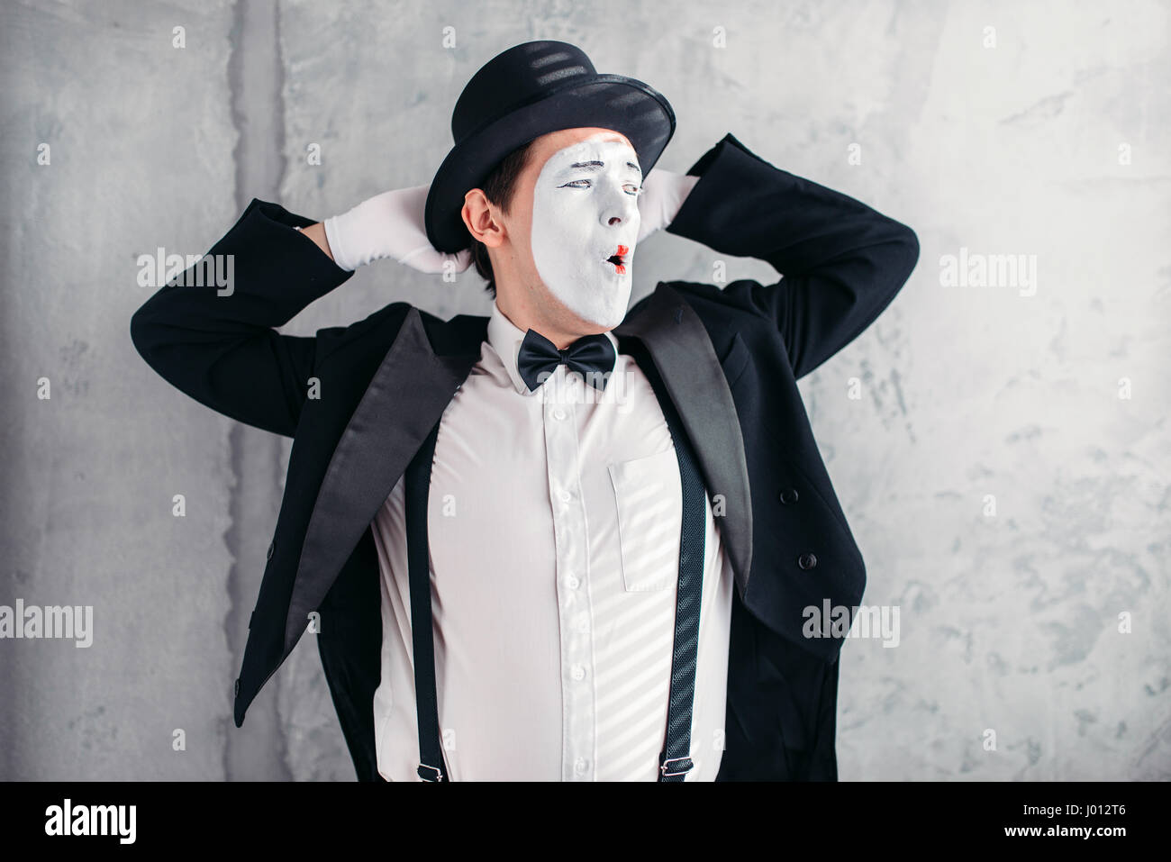Pantomime artist with makeup mask. Mime in suit, gloves and hat. April ...