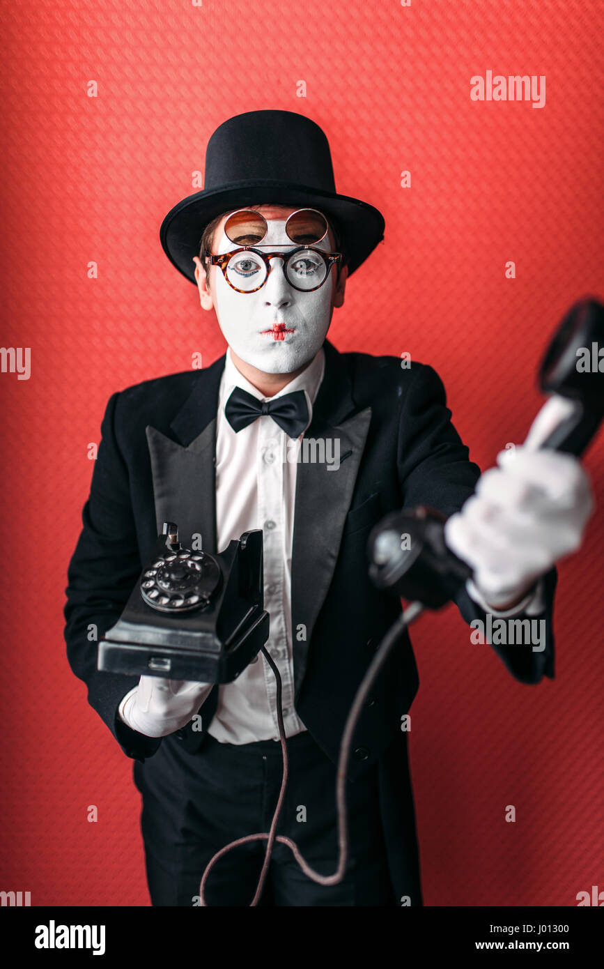 Mime theater actor performing with old telephone. Comedy pantomime ...