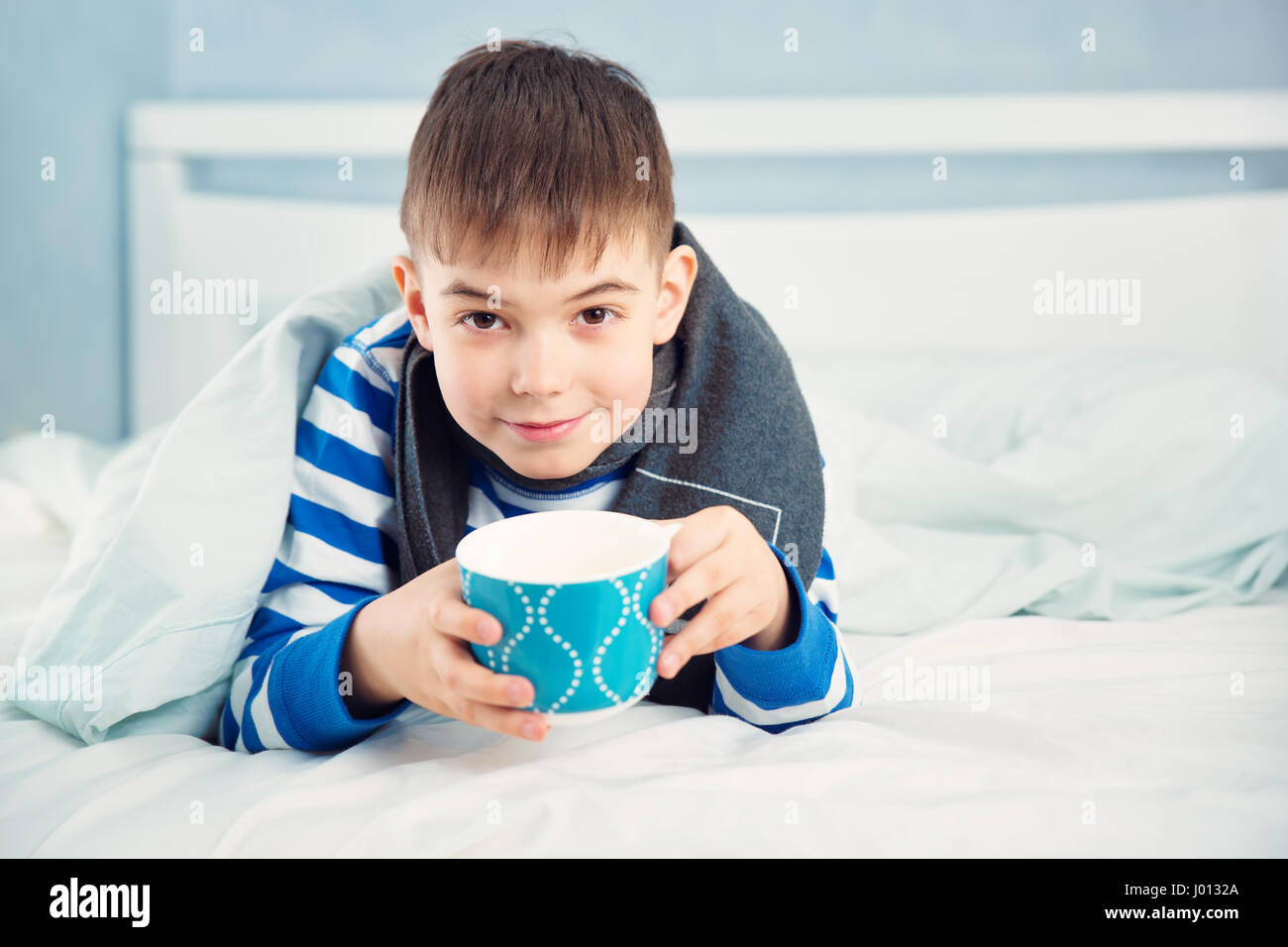 Ill boy lying in bed Stock Photo - Alamy