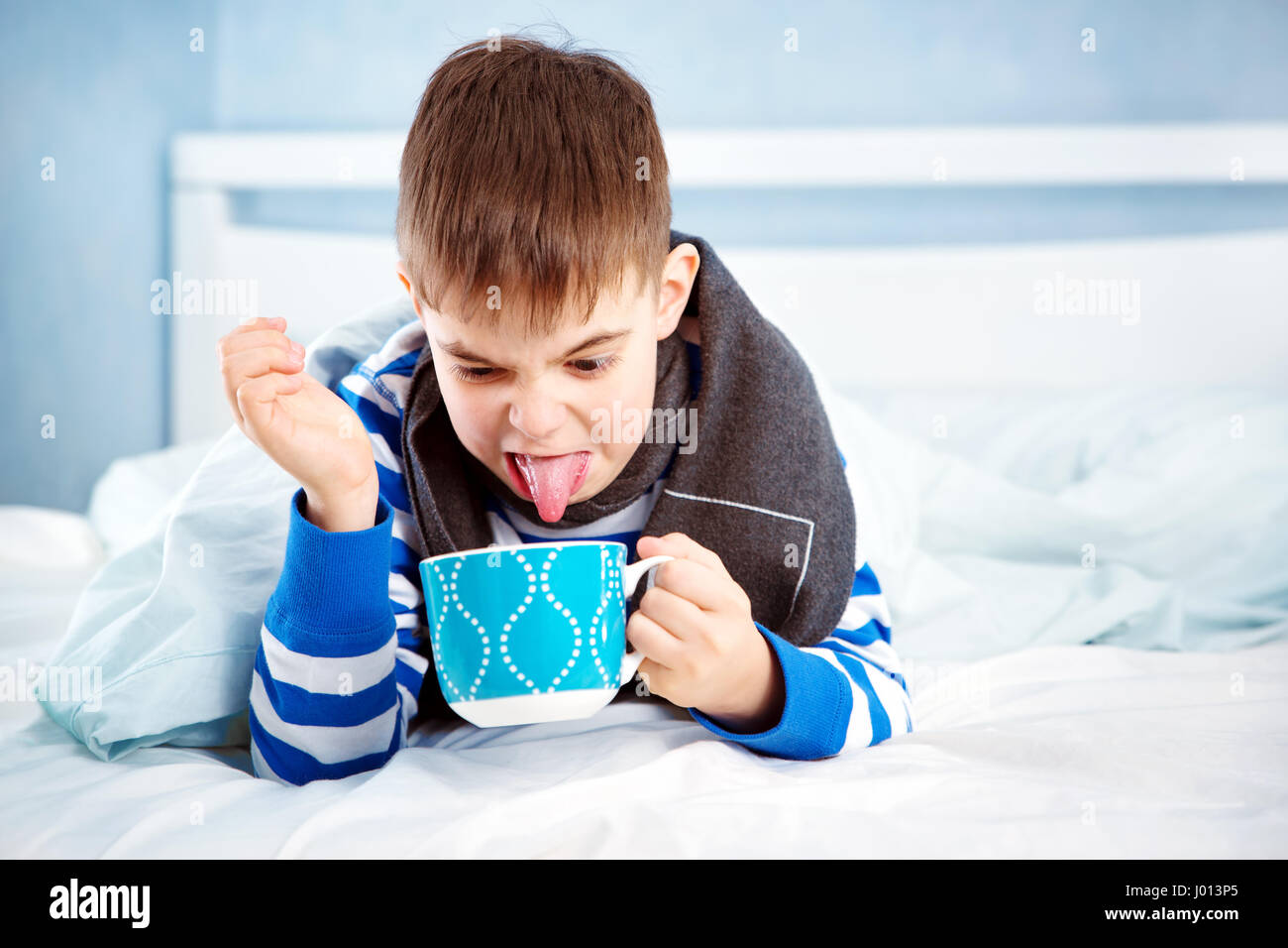 Ill boy lying in bed Stock Photo - Alamy