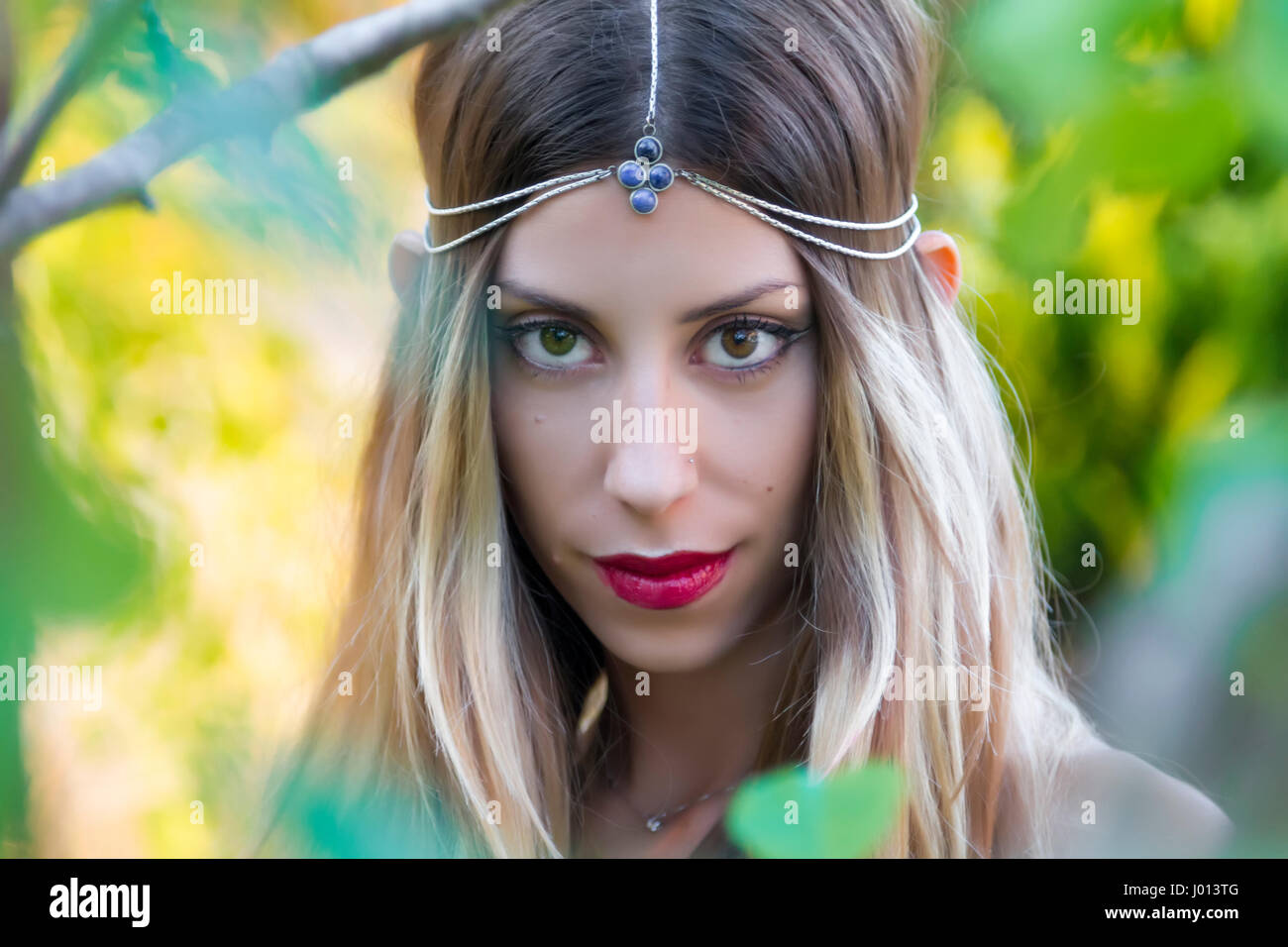 Elf woman in a magical forest wearing a head piece. Soft focus Stock ...