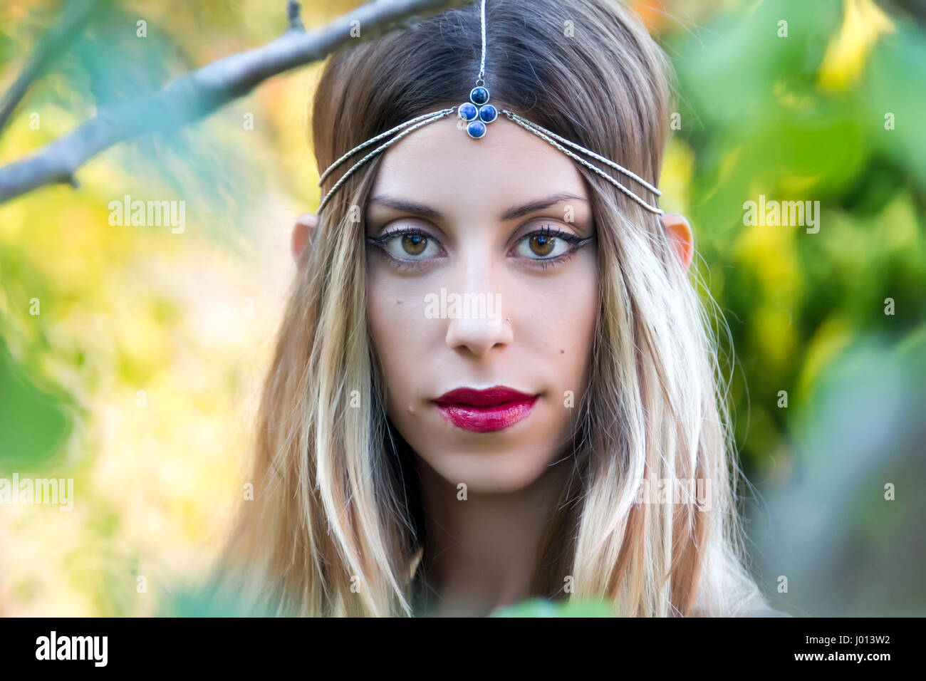 Elf woman in a magical forest wearing a head piece. Soft focus Stock ...