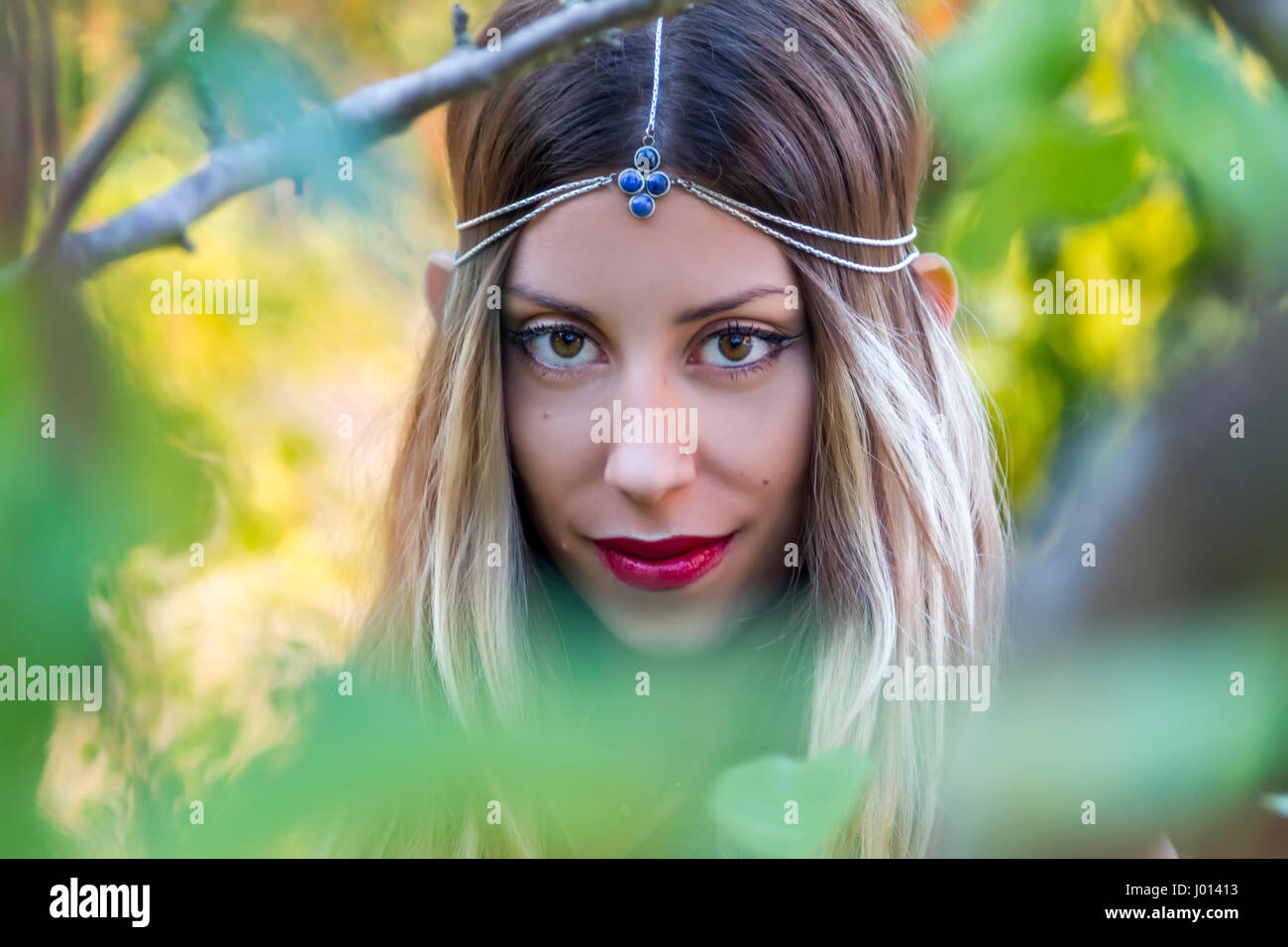 Elf woman in a magical forest wearing a head piece. Soft focus Stock ...