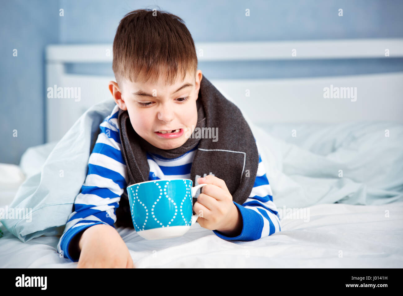 Ill boy lying in bed Stock Photo - Alamy