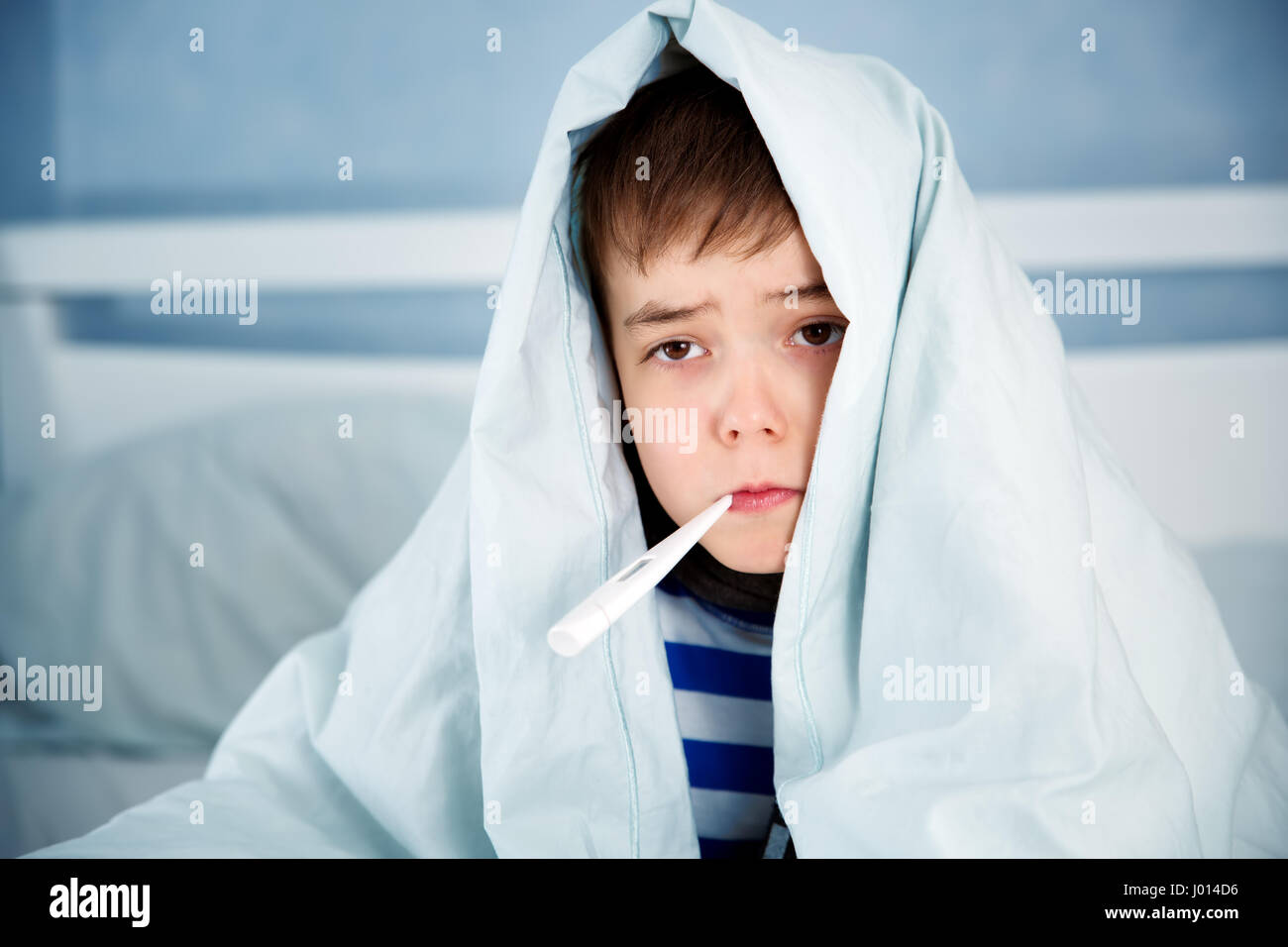 Ill boy lying in bed Stock Photo - Alamy