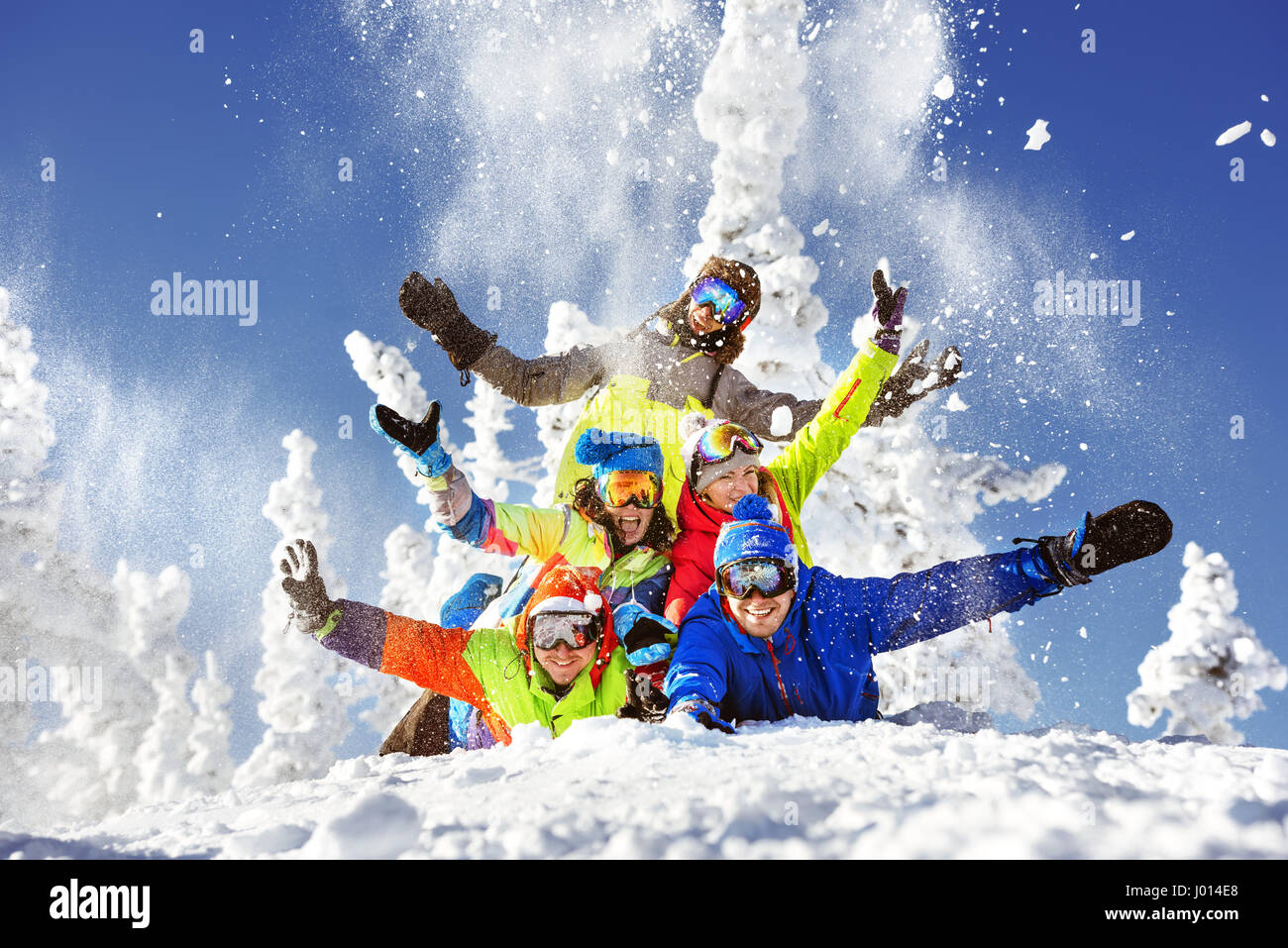 Group of five happy snowboarders and skiers Stock Photo - Alamy