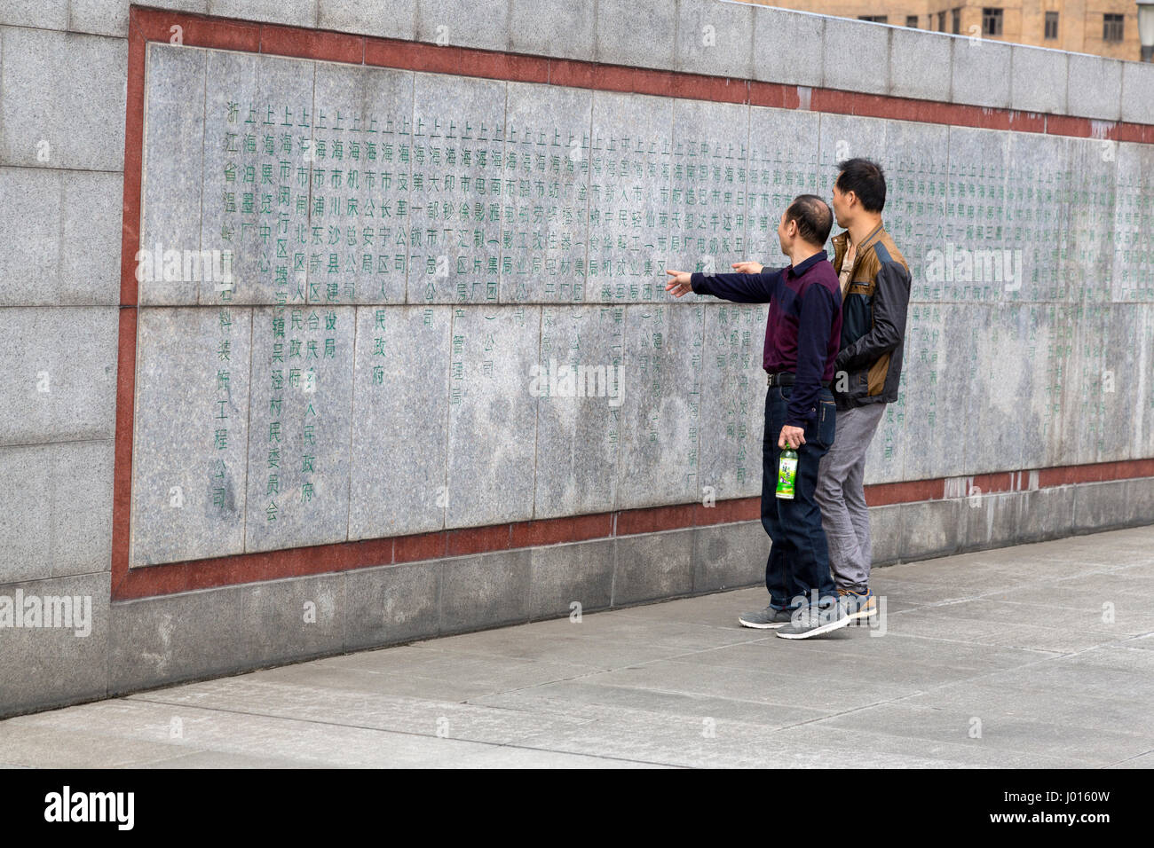China, Shanghai. Two Visitors Reading Inscriptions at the Monument to ...