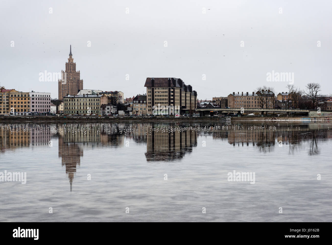city light reflections over water at the colorful panorama of Riga ...
