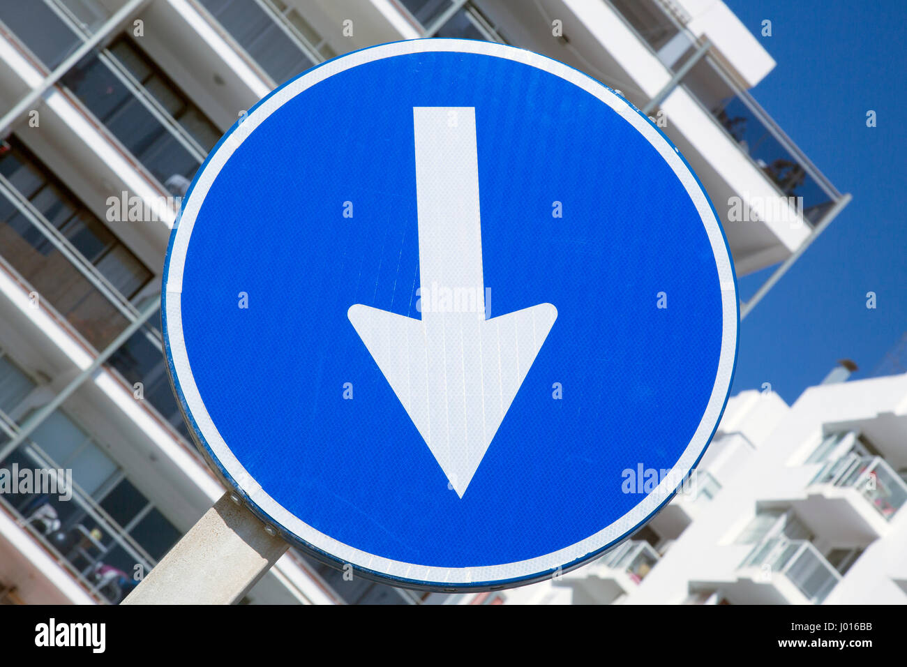 Down Arrow Sign in Urban Setting Stock Photo - Alamy