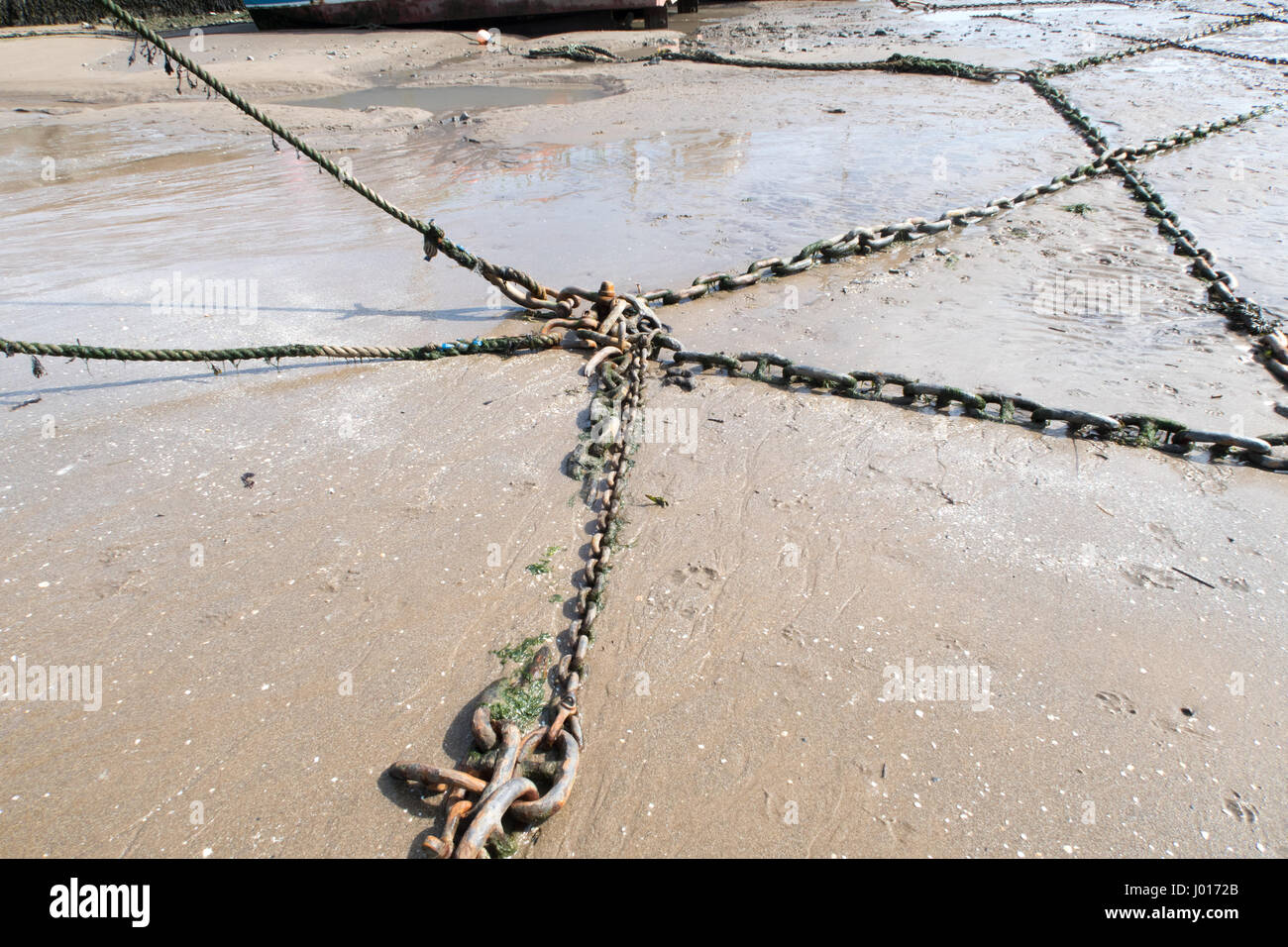 Sandy beach scene with lots of big chains for anchoring boats Stock ...