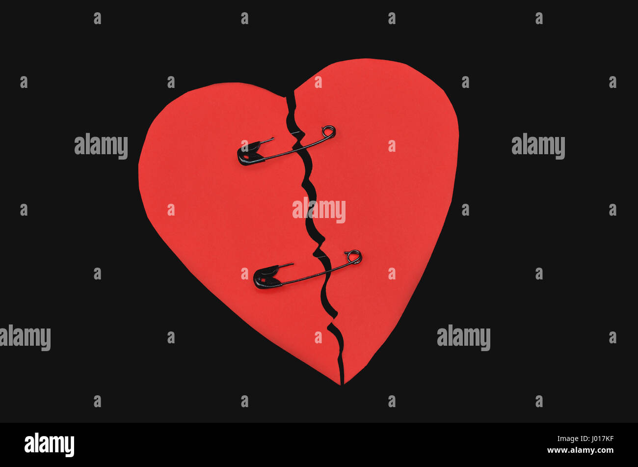 A broken heart tied with pins Stock Photo - Alamy