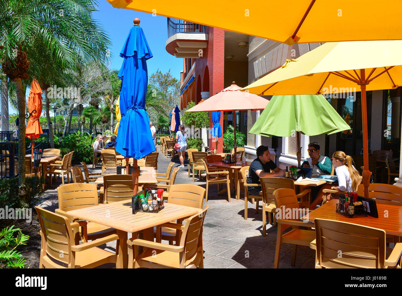 Sunny and colorful patio with diners at the Mango's Dockside Bistro ...