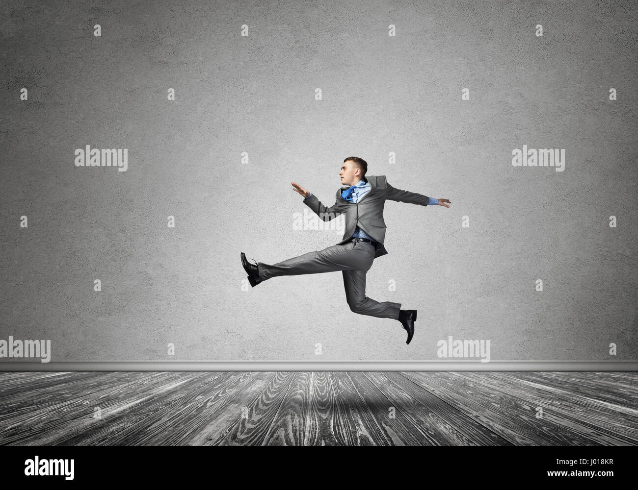 Businessman jumping high Stock Photo - Alamy