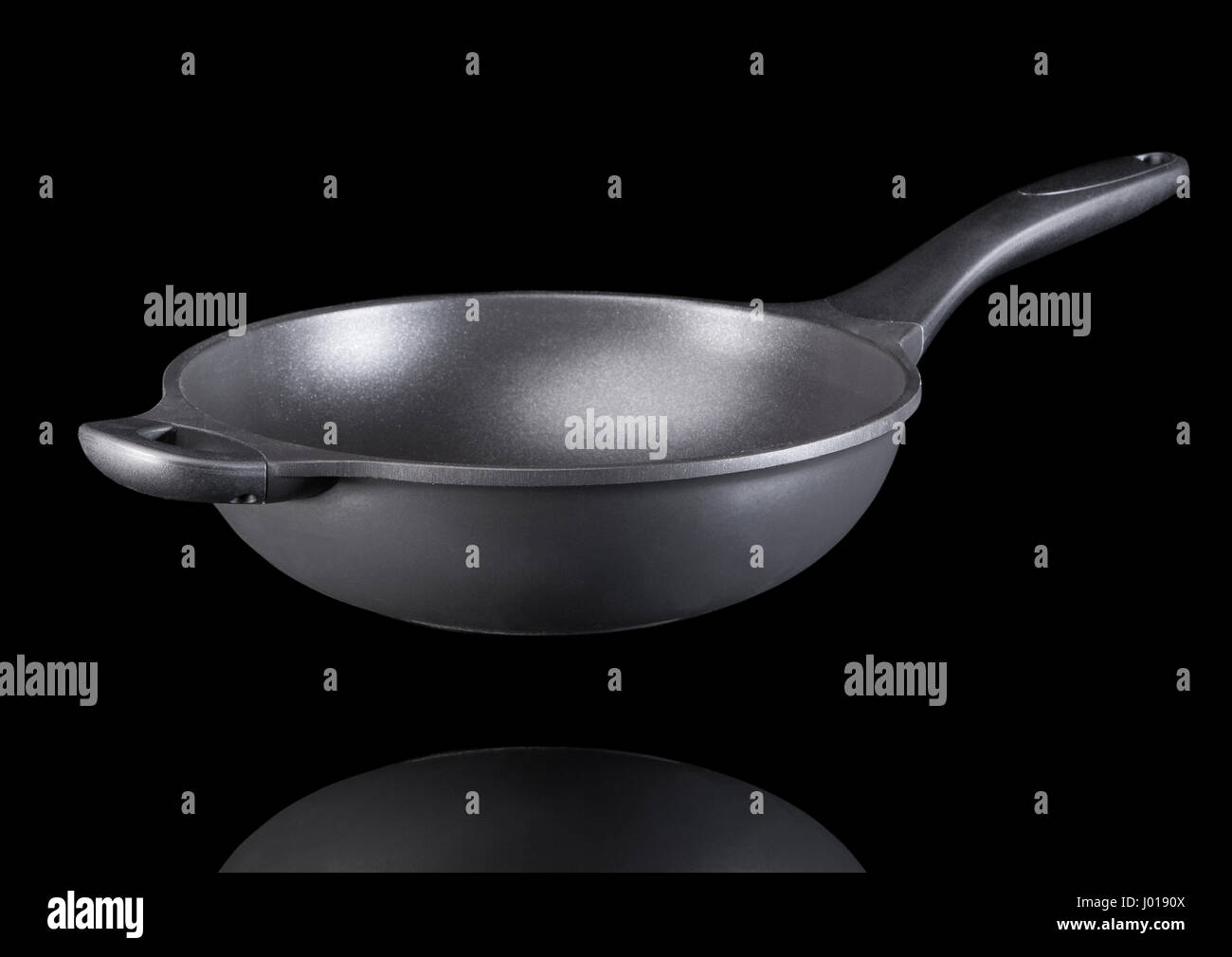 Teflon Pan, angle view. Isolated on black background Stock Photo - Alamy