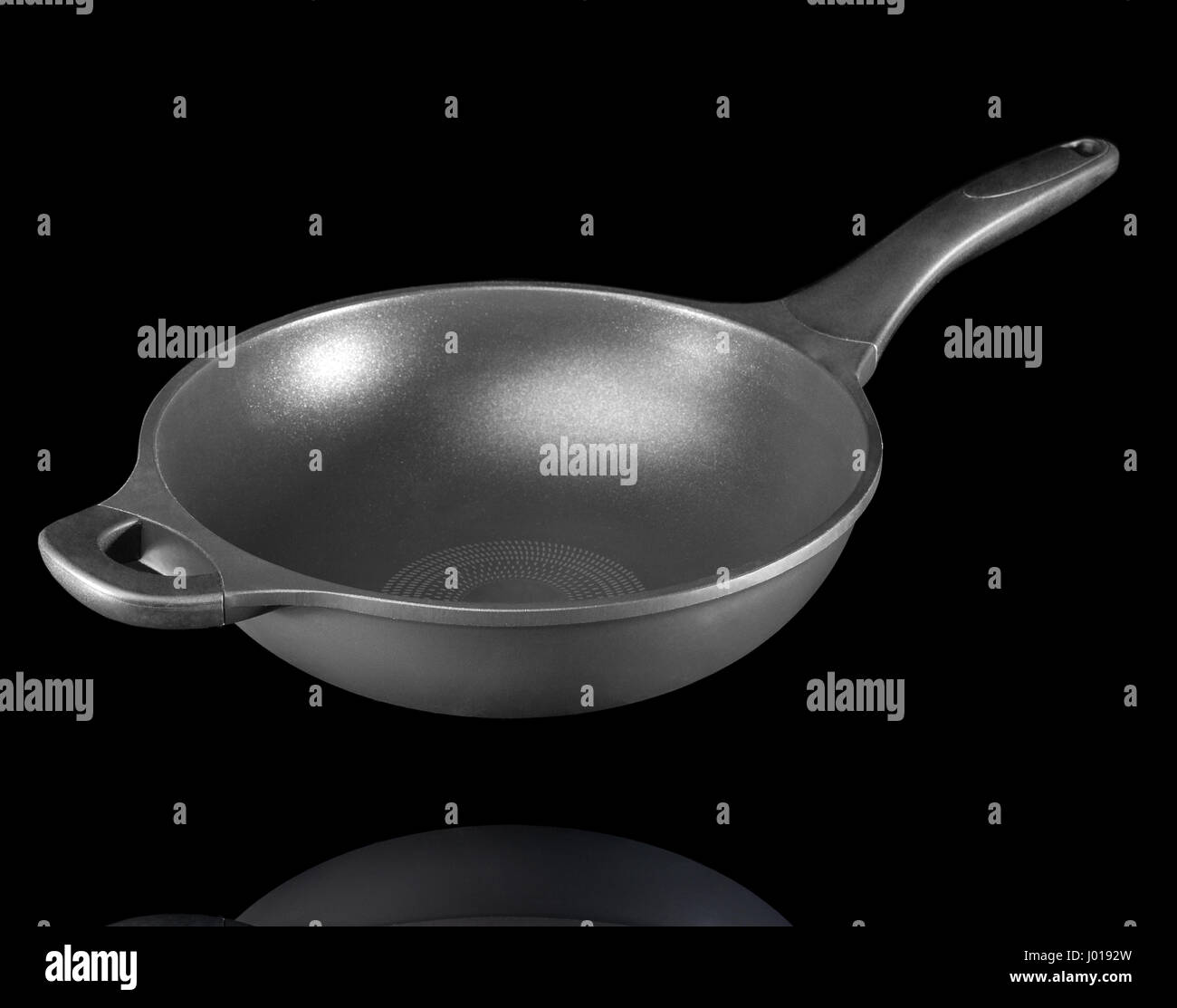 Teflon Pan, angle view. Isolated on black background Stock Photo - Alamy