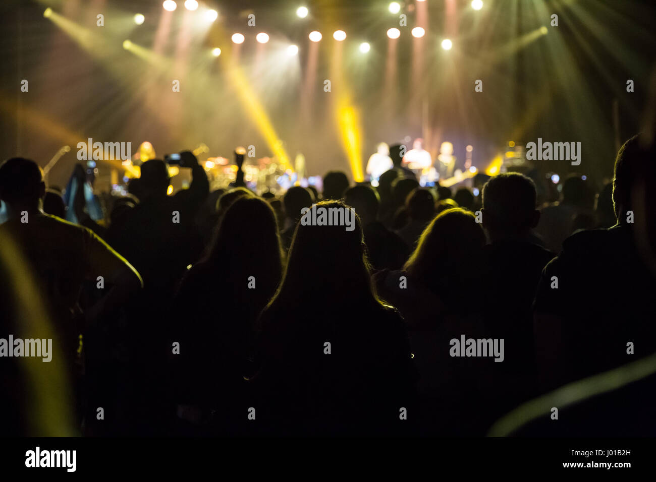 Crowd at concert and blurred stage lights . Close up of photographing ...