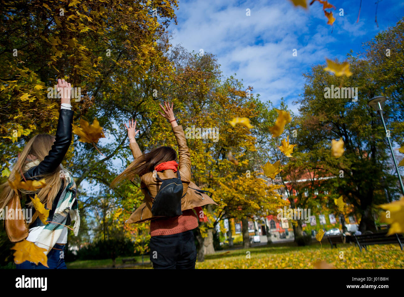 Mellow autumn. Two girls are students cheerfully spend time in the city ...