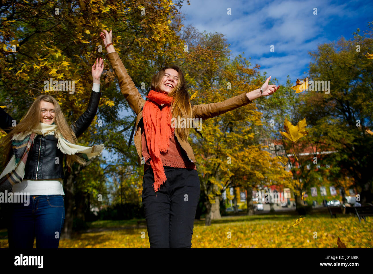 Mellow autumn. Two girls are students cheerfully spend time in the city ...