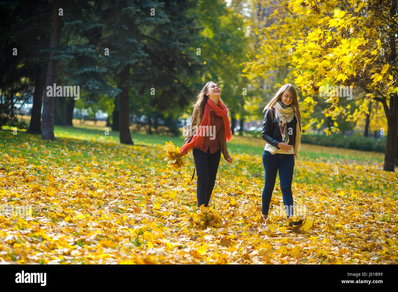Mellow autumn. Two girls are students cheerfully spend time in the city ...
