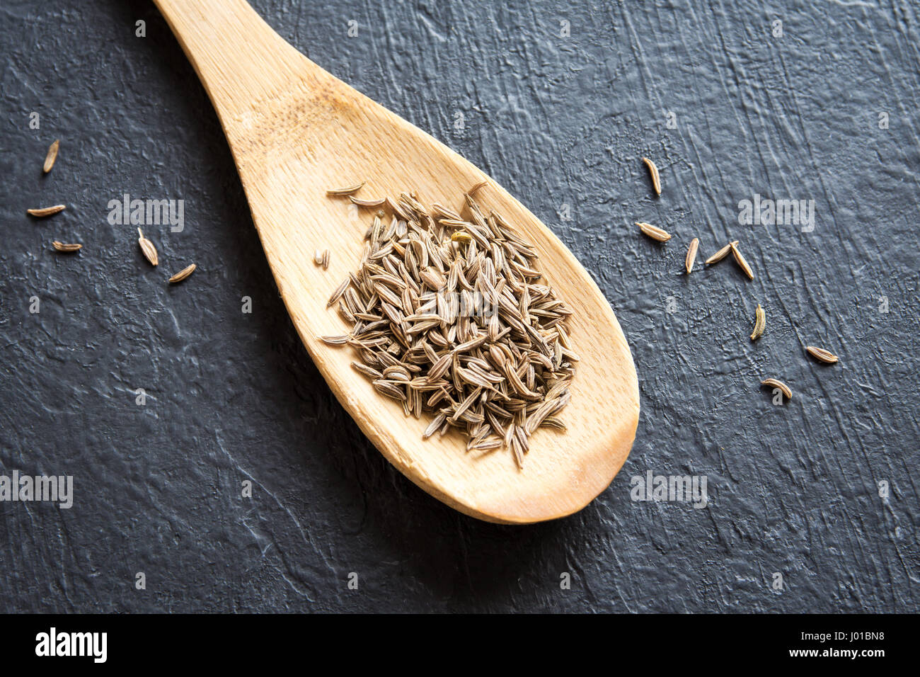 Cumin seeds. Close up image of cumin (zira) seeds on rustic wooden ...
