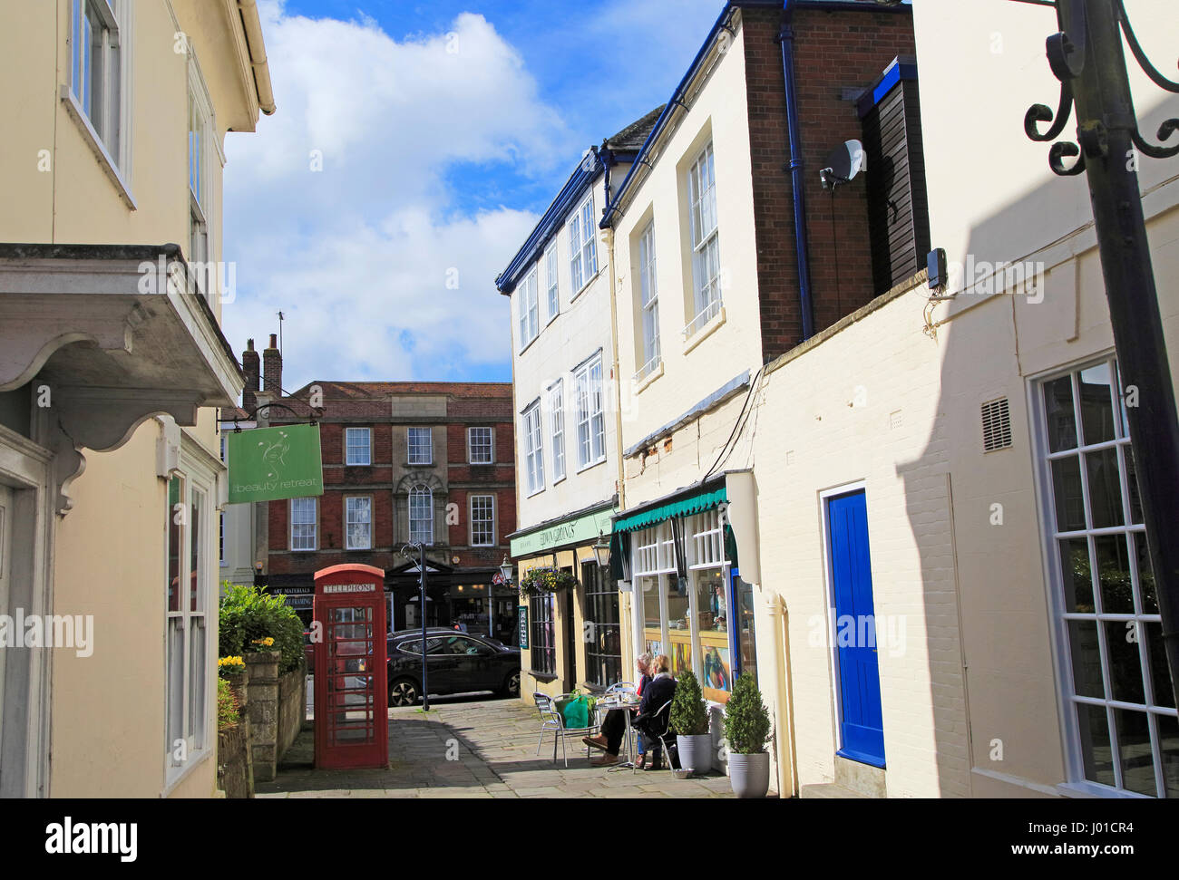 People sitting outside cafe in quiet back street, Devizes, Wiltshire ...