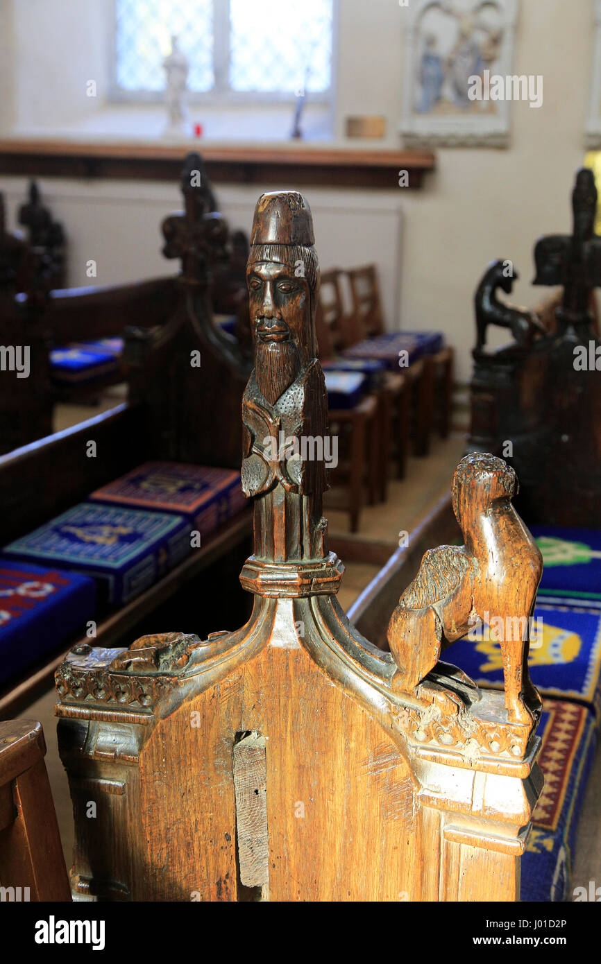 Ornately decorated wooden pew end Ufford church, Suffolk, England, UK ...