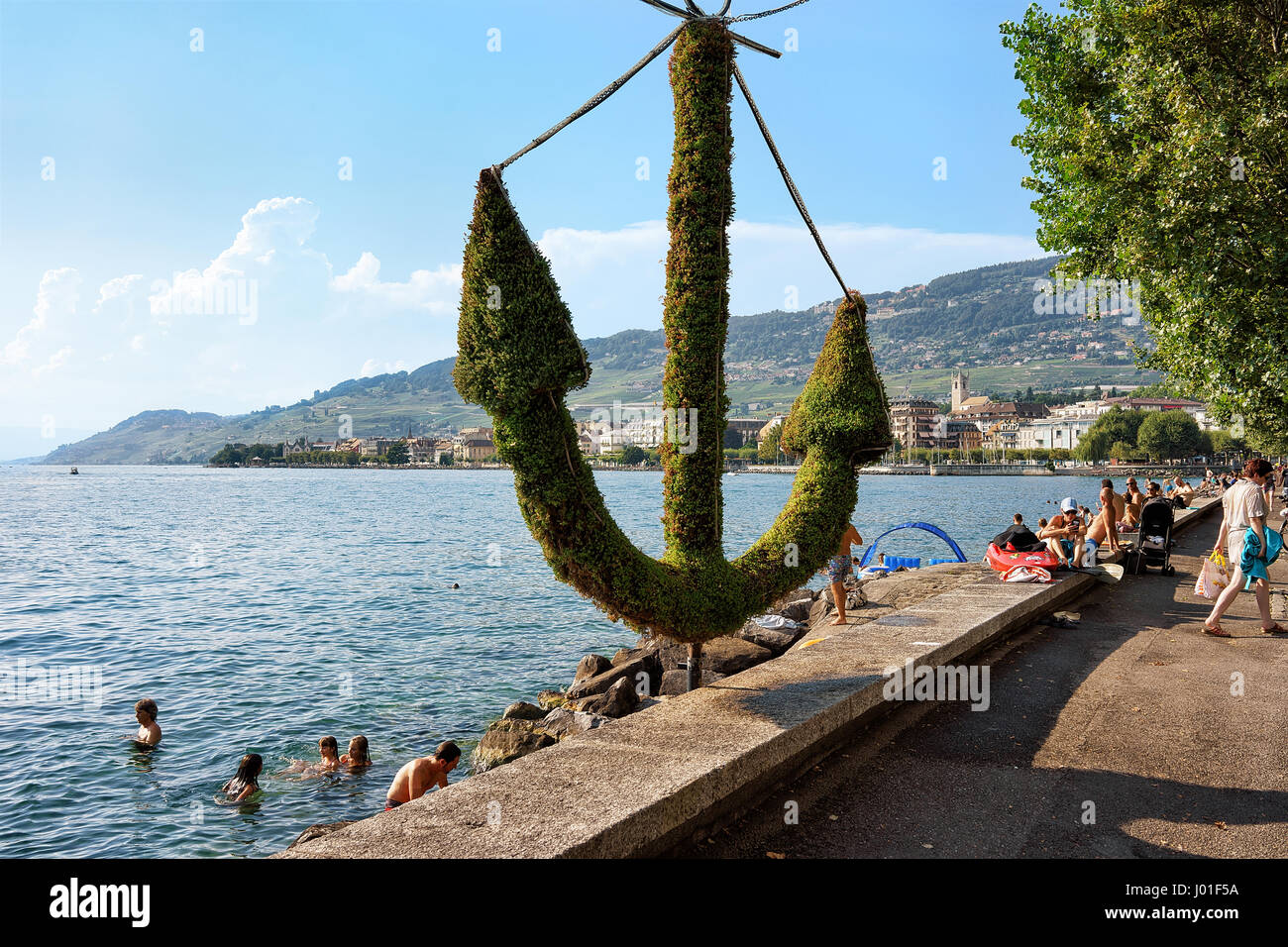 Vevey, Switzerland - August 27, 2016: People swimming at the embankment ...