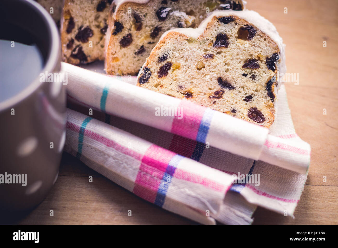 Stollen, traditional German Christmas yeast cake with raisins served ...