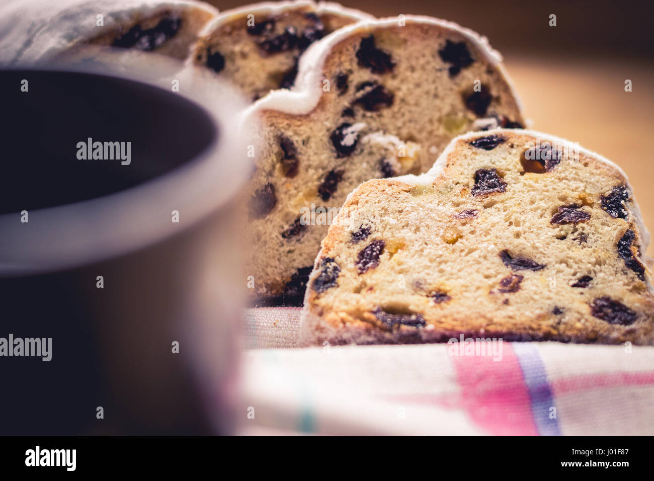 Stollen, traditional German Christmas yeast cake with raisins served ...