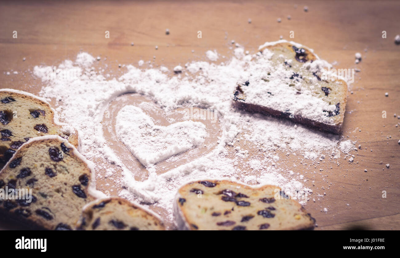 Stollen, traditional German Christmas yeast cake with raisins on wooden ...