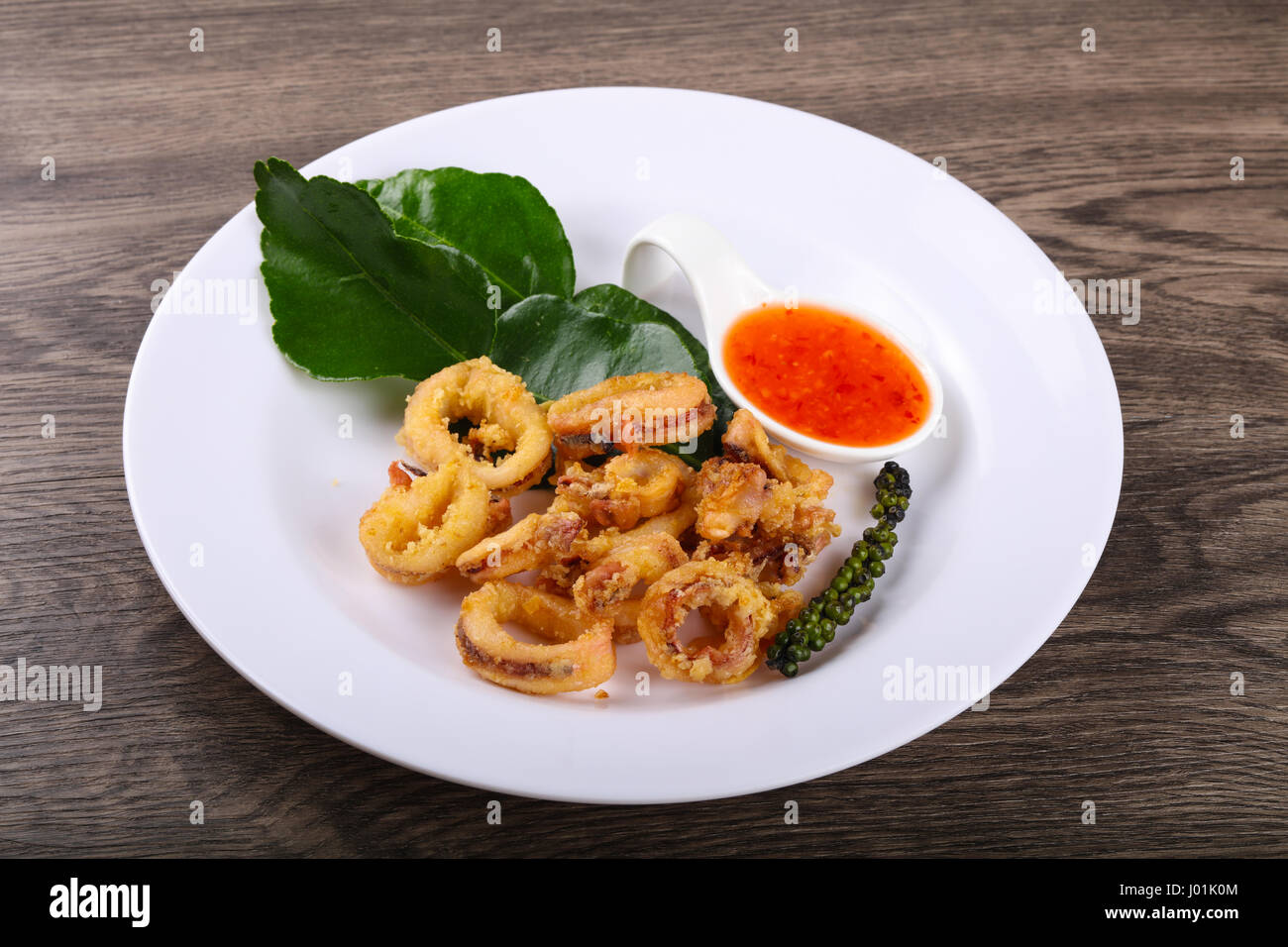 Fried squid rings with hot spicy sauce Stock Photo - Alamy
