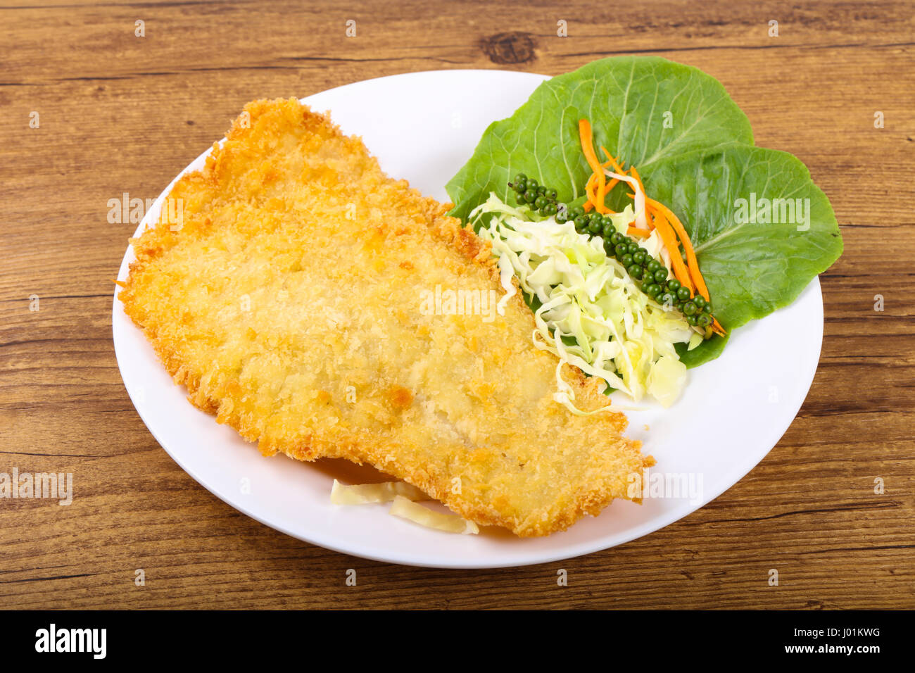 Fried Dory fish with salad on the wood background Stock Photo - Alamy