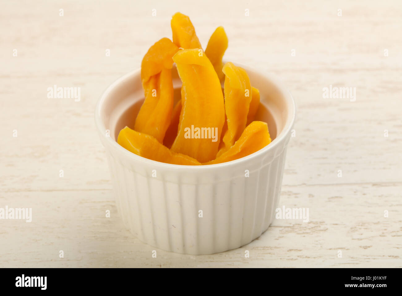 Dry mango chips heap in the bowl Stock Photo - Alamy