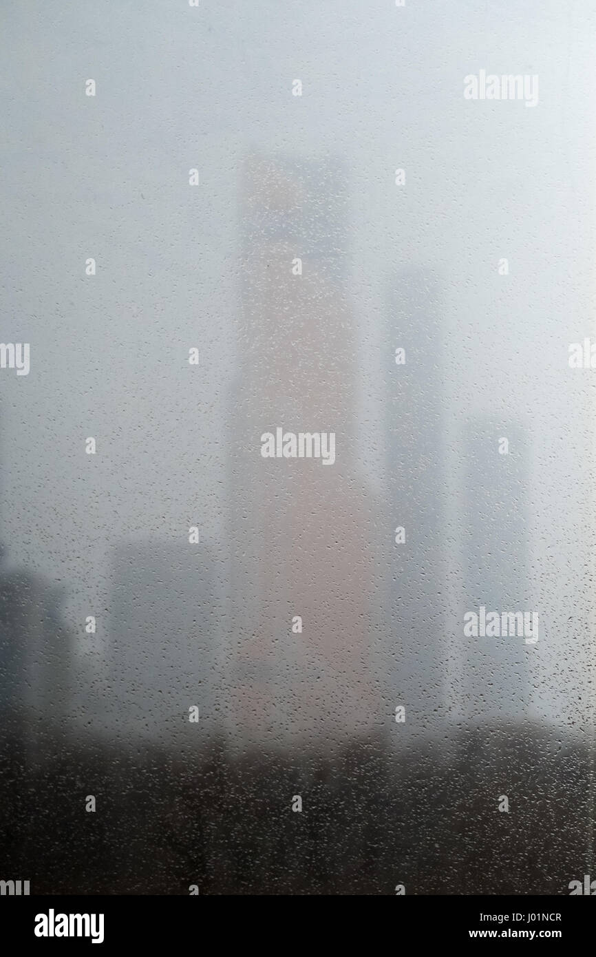 Skyscrapers outside the window, it's raining Stock Photo - Alamy