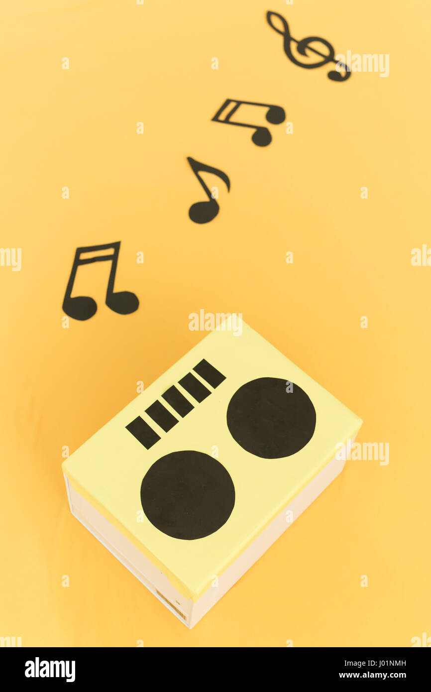 Musical background. Notes and radio cut out from a cardboard on a ...