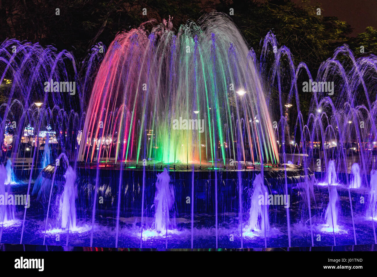 Colored fountain at might in circle inn Hai Phong, Vietnam. Brightly ...