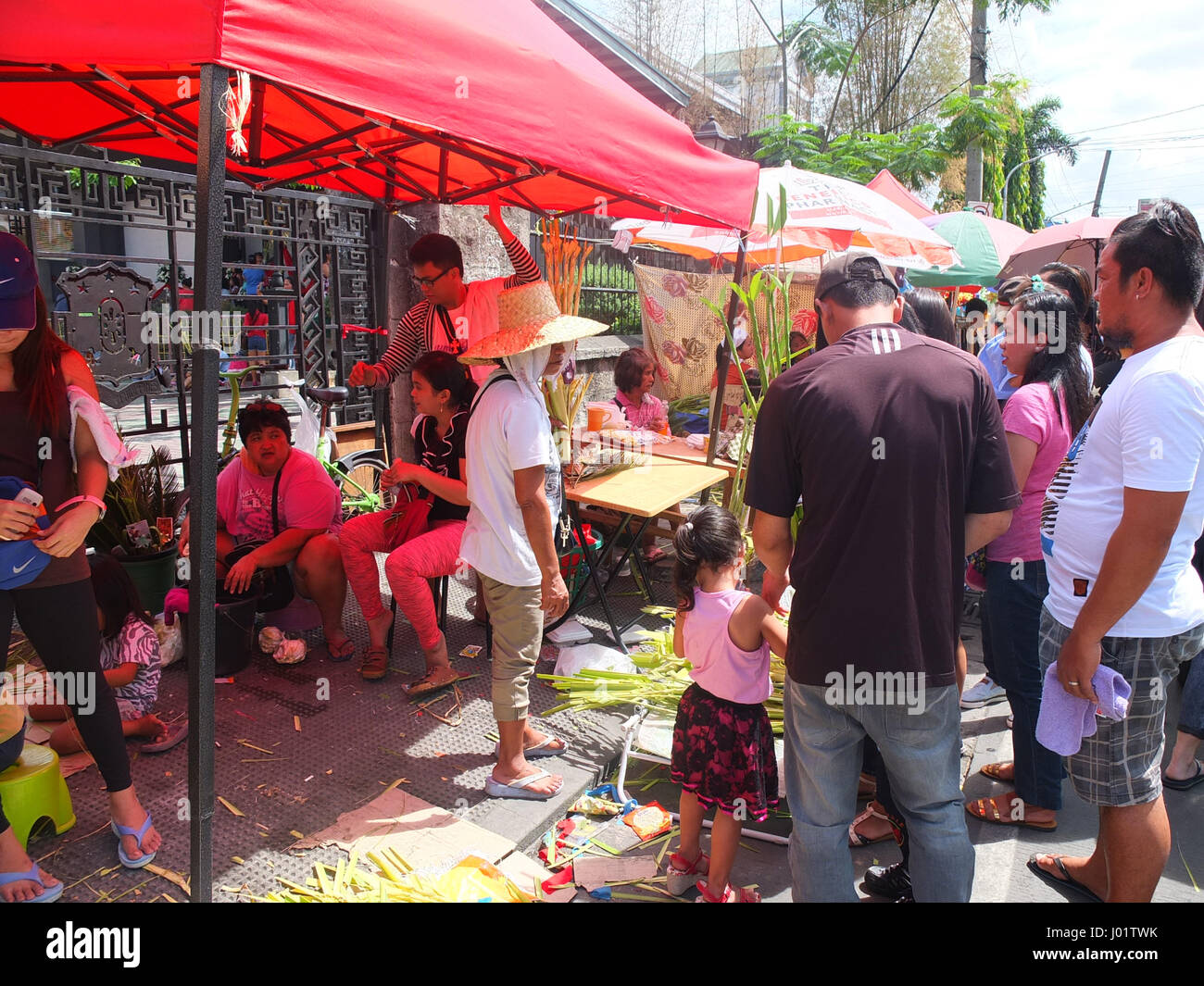 Devotess piling up themselves at palm frond vendors to buy palm fronds ...