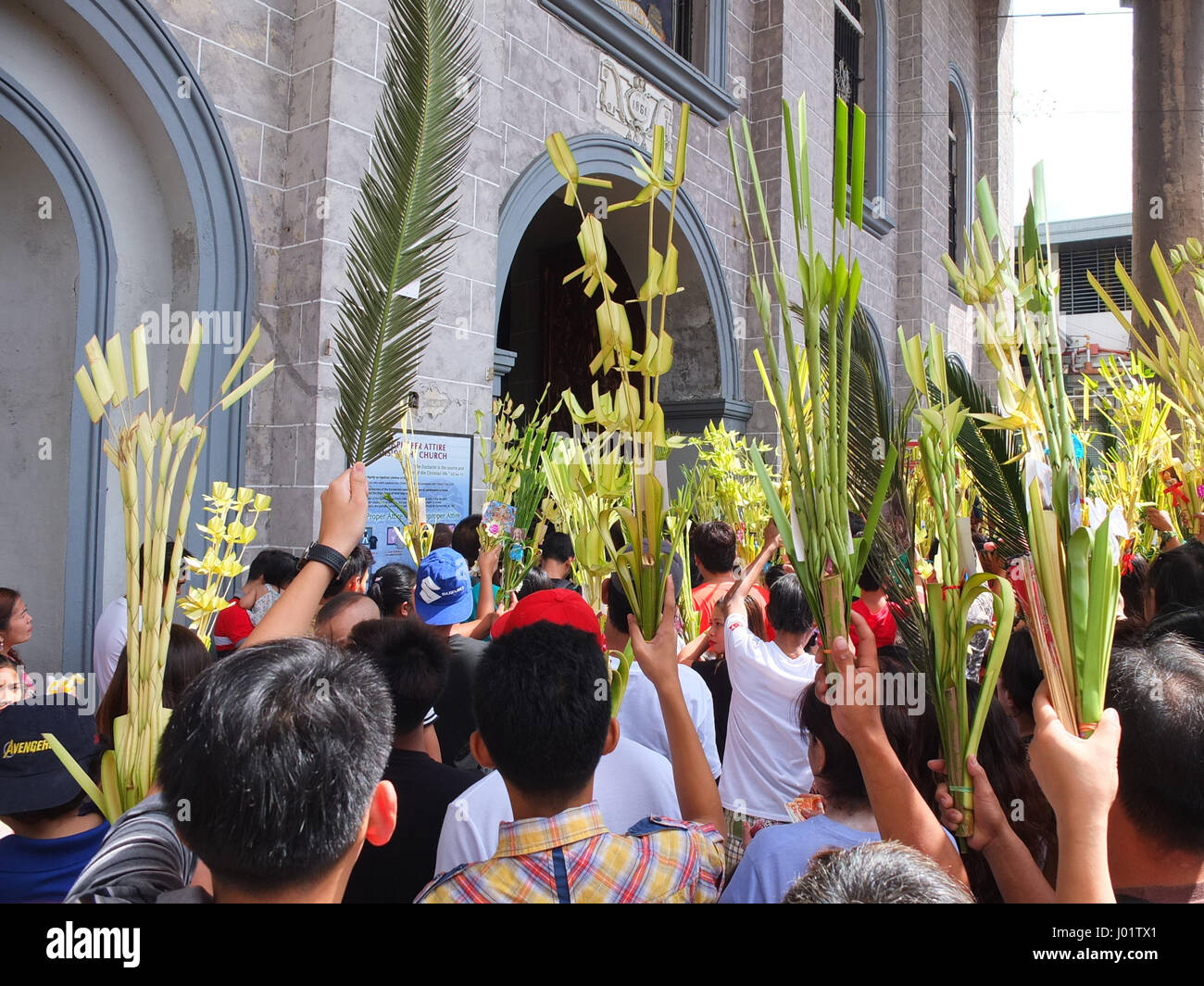 Catholic Devotees waving their palm fronds celebrating Palm Sunday ...