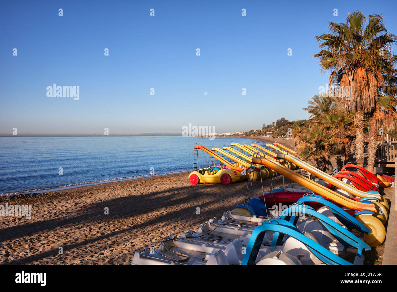 Water bikes, pedal boats with slide on a beach in Marbella, resort city ...