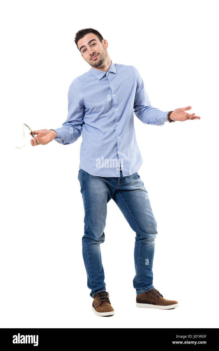 Smiling confused businessman shrugging shoulders looking at camera ...