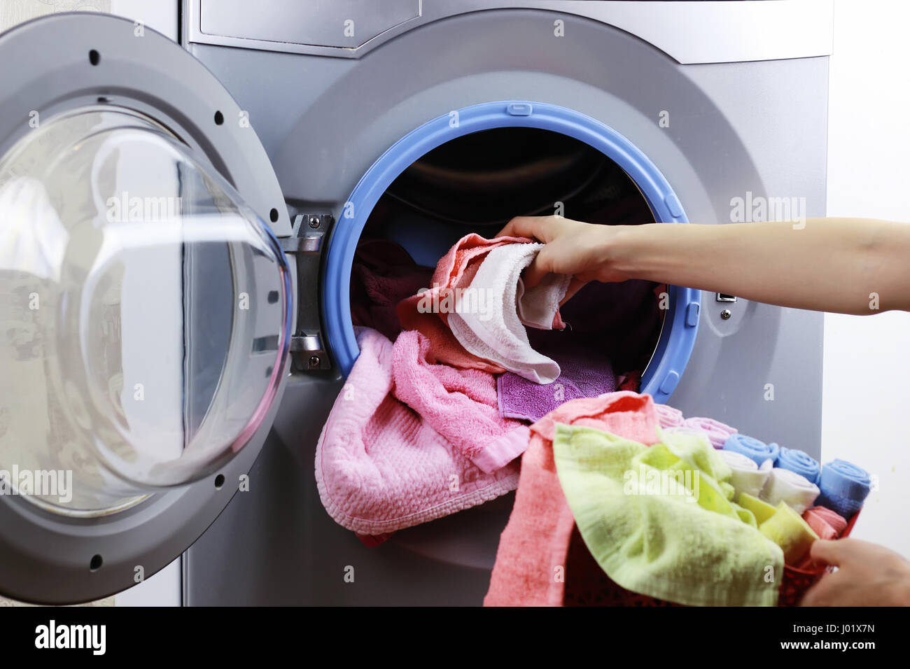 put cloth in washer Stock Photo - Alamy