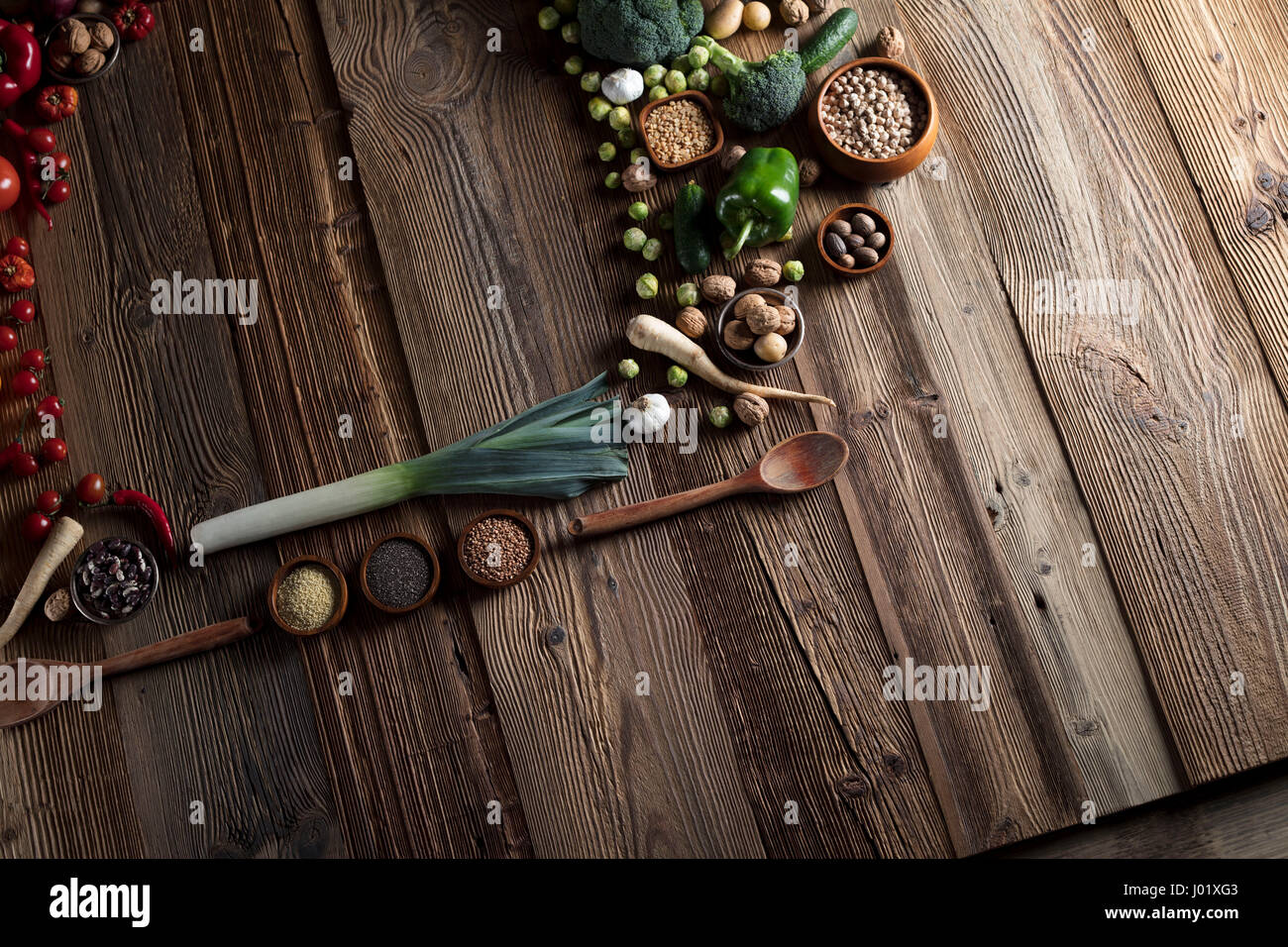 Vegetables and spices. Wooden table, top view. Different vegetables and ...