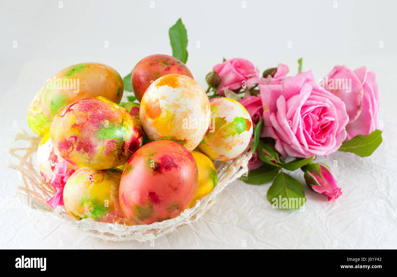 Easter eggs in a bowl and pink roses bouquet Stock Photo - Alamy