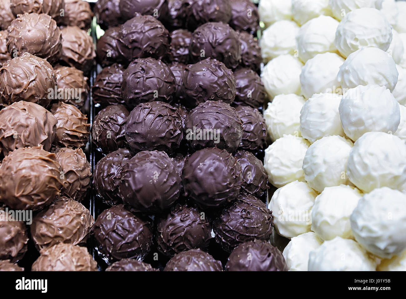 Assortment of milk and white Swiss chocolate truffles Stock Photo - Alamy