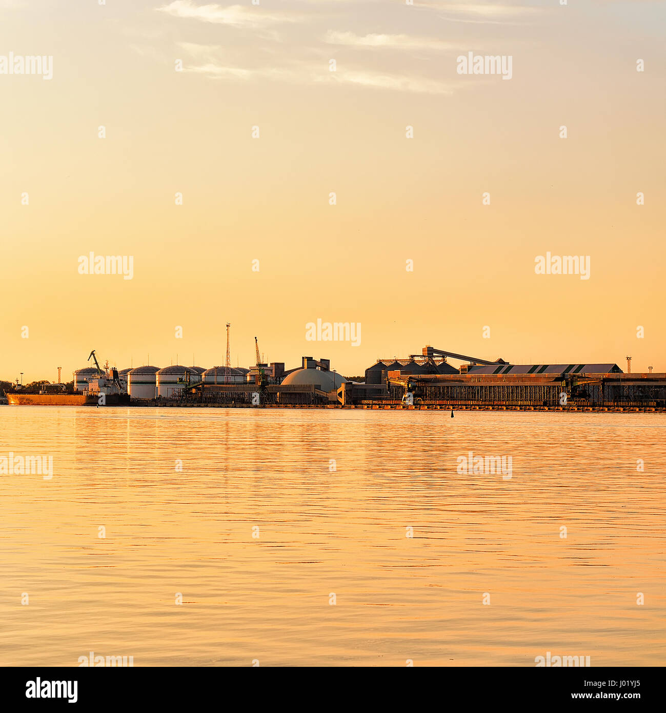 Oil tanks in Baltic sea in Port, Klaipeda, Lithuania. Magic golden ...