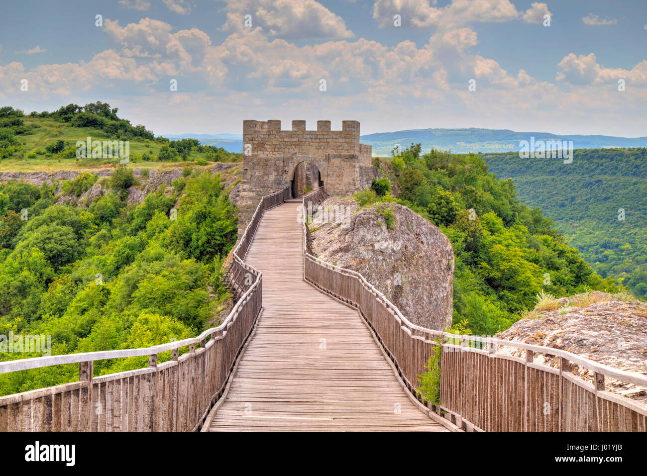 Stone walls and gate with wooden bridge of medieval fortress Stock ...